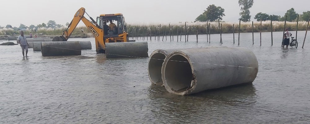 Temporary bridge being built over Triyuga River